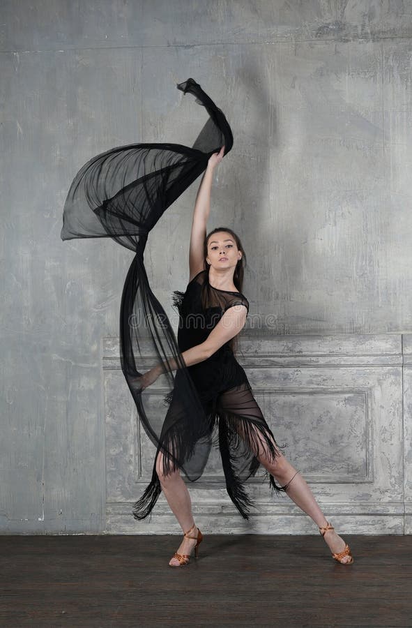 Woman Dancer in Motion with a Cloth Against the Wall Stock Image ...