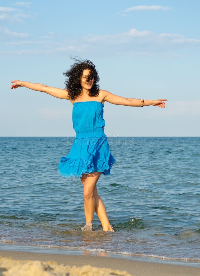 Woman dancing in the sea stock photo. Image of hoilday - 26175130