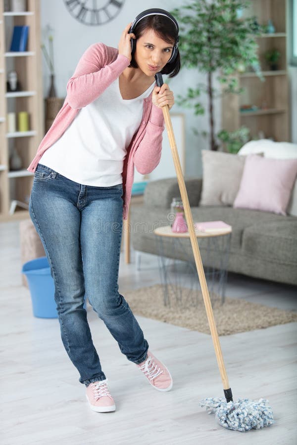 Woman Dancing and Singling while Mopping Floor Stock Photo - Image of ...