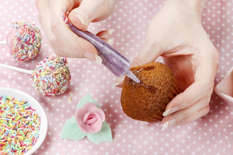Woman decorating muffins stock image. Image of cupcakes - 38543973