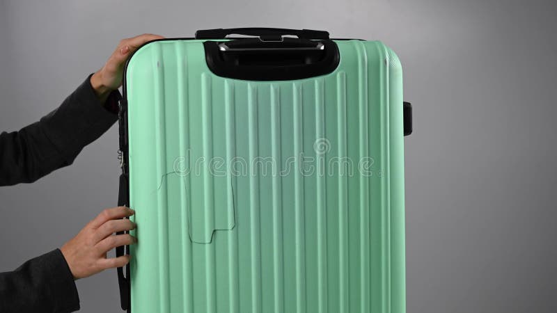A Woman Demonstrates a Broken Suitcase on a White Background. Damaged ...