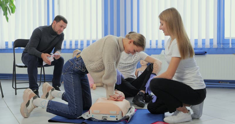 Woman Demonstrating CPR on Mannequin in First Aid Class. Stock Photo ...