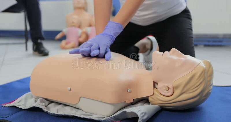 Woman Demonstrating CPR on Mannequin in First Aid Class. Stock Footage ...