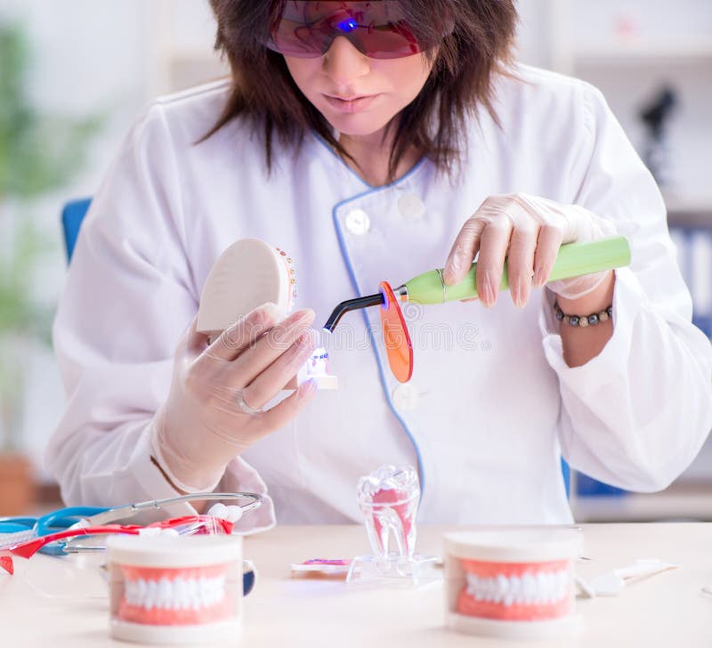 Woman Dentist Working on Teeth Implant Stock Image - Image of light ...
