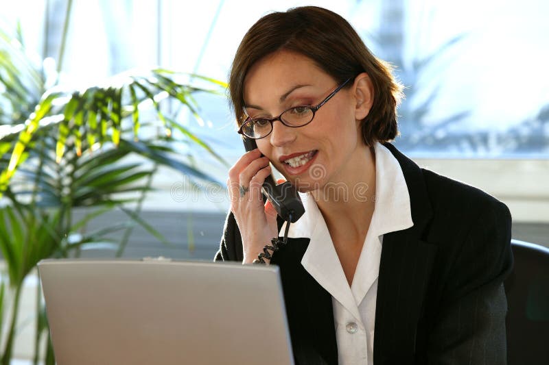 Woman at Desk with Laptop Computer and Phone Stock Image - Image of ...