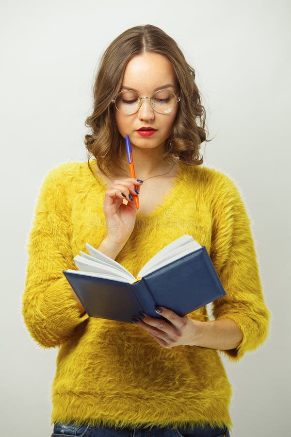 Woman with Diary in Hands and Pen Thinks To Write Something Over White ...