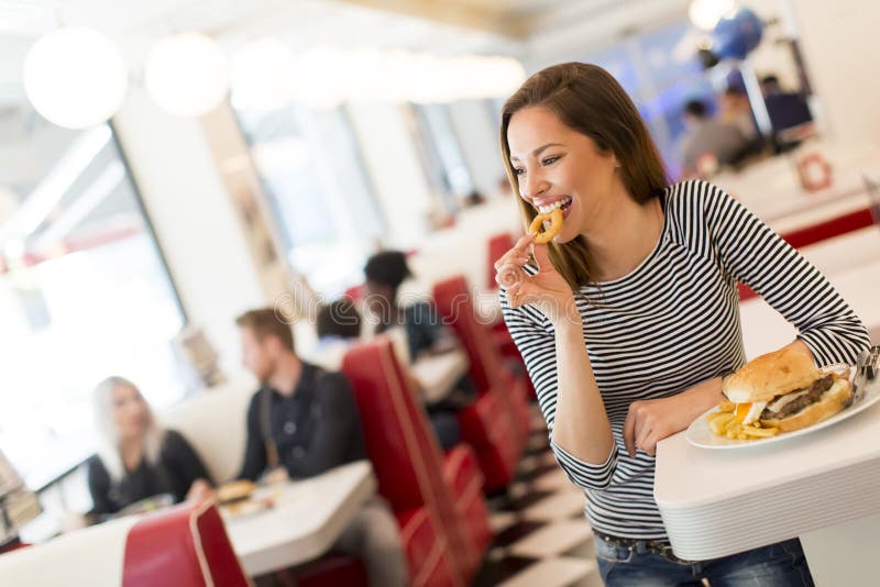 Woman in the diner stock image. Image of cheeseburger - 76664197