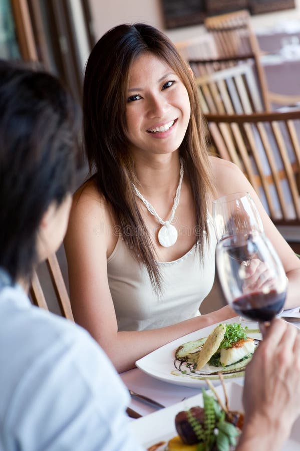 Woman at Dinner stock photo. Image of enjoying, asian - 4679676
