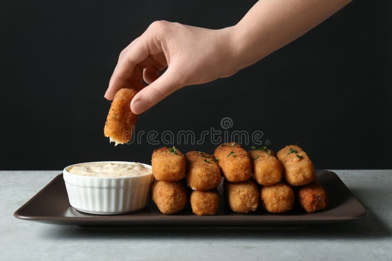 Woman Dipping Cheese Stick into Sauce at Table Stock Image - Image of ...