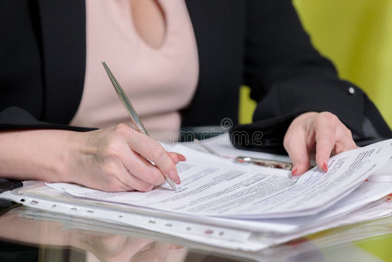 A Woman Director Working in the Office Sits at the Table, Signs ...