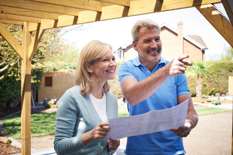 Mature Woman Discusses Plan with Landscape Gardener Stock Image - Image ...