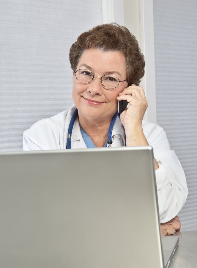 Woman Doctor at Computer, Talking on Phone Stock Image - Image of cell ...