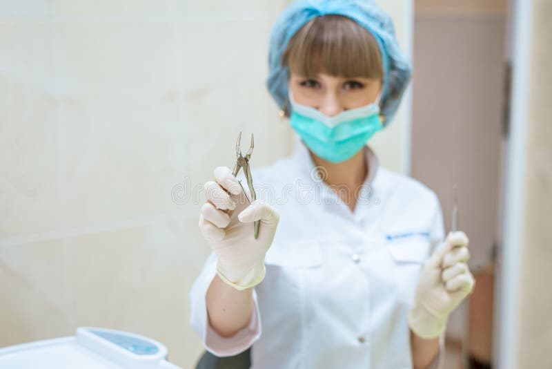 Woman Doctor in Mask with Tools in Hand Stock Photo - Image of clinic ...