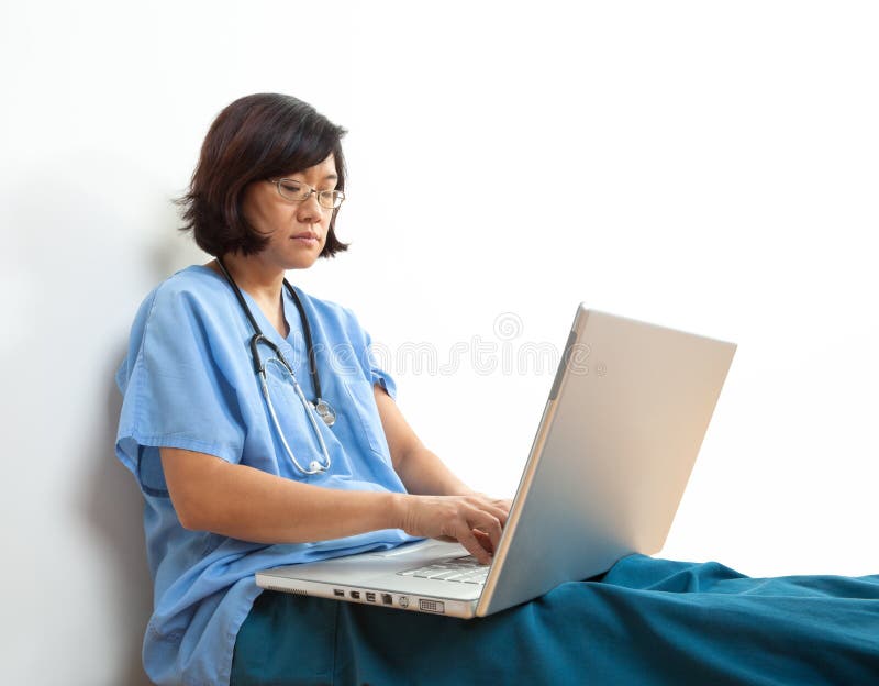 Doctor and Nurse Reviewing on Laptop Computer in O Stock Photo - Image ...