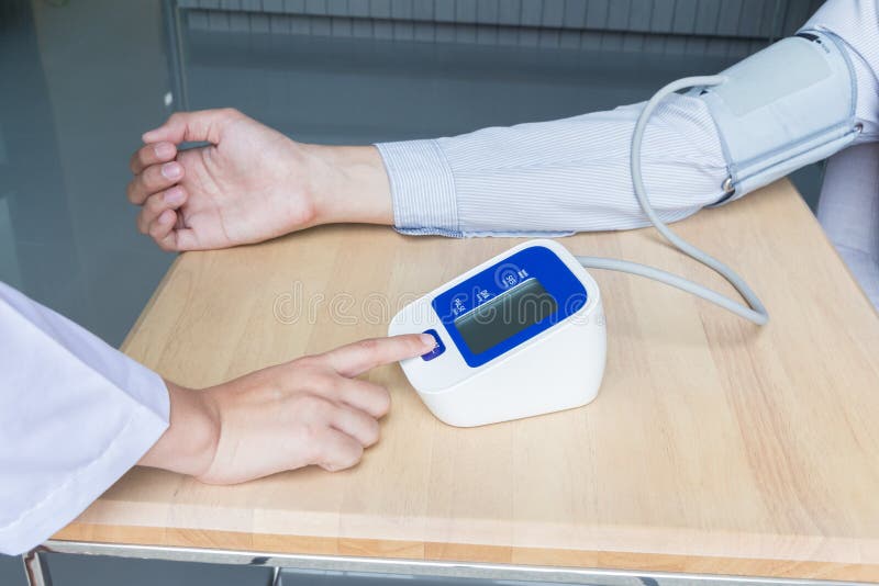 Woman Doctor Press Start Button on Blood Pressure Stock Image - Image ...