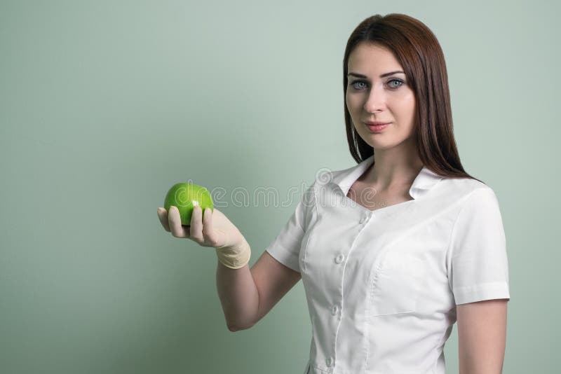 Woman Doctor Shows Green Apple Hygiene And Health Of Teeth Stock
