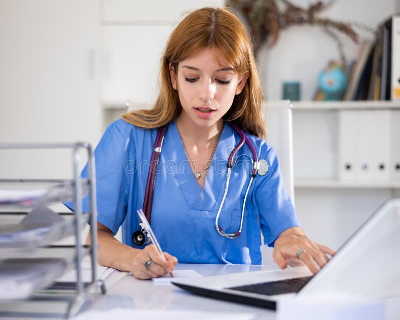 Woman Doctor Sitting at Workplace with Computer in Her Office Stock ...