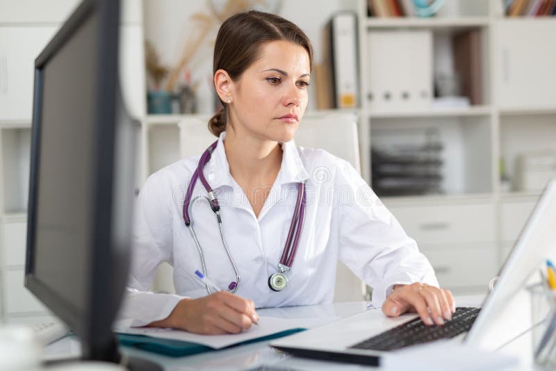 Woman Doctor Sitting at Workplace with Computer in Her Office Stock ...