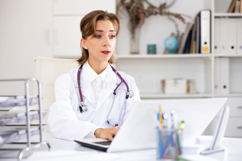 Woman Doctor Sitting at Workplace with Computer in Office Stock Image ...