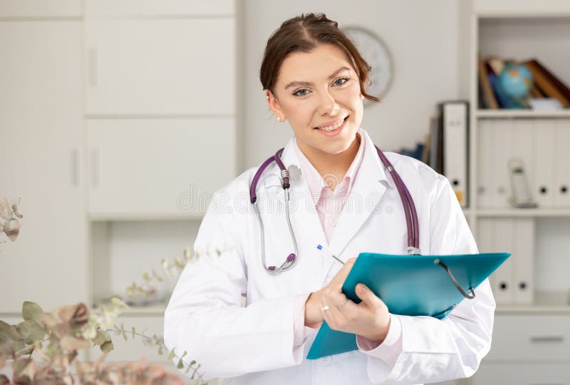Woman Doctor is Standing with Documents in Clinic Stock Photo - Image ...