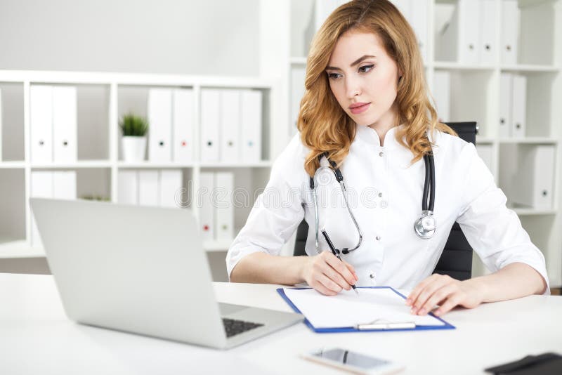 Woman doctor taking notes stock image. Image of care - 76452059