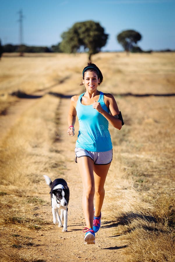 Woman and Dog Running in Rural Countryside Path Stock Image - Image of ...