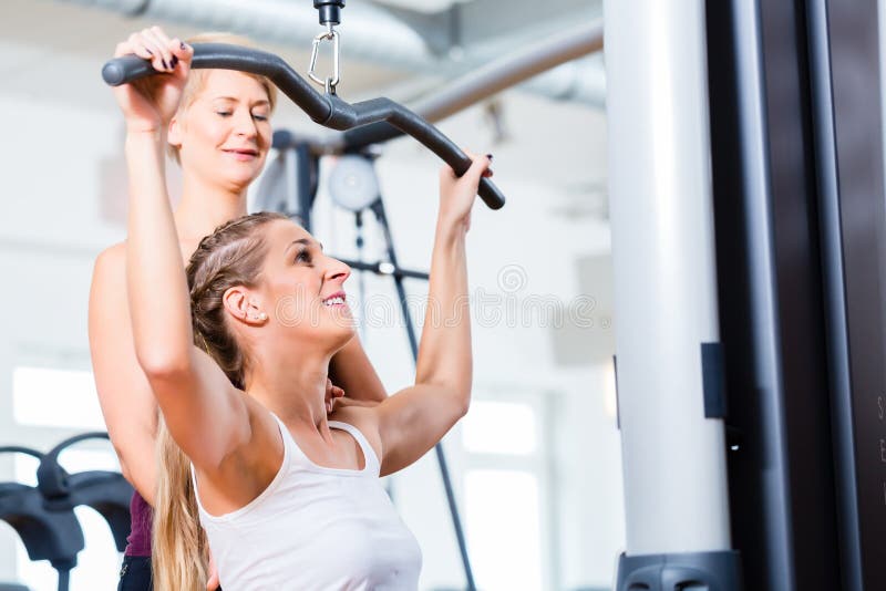 Woman Doing Back Training with Trainer in Gym Stock Image - Image of ...