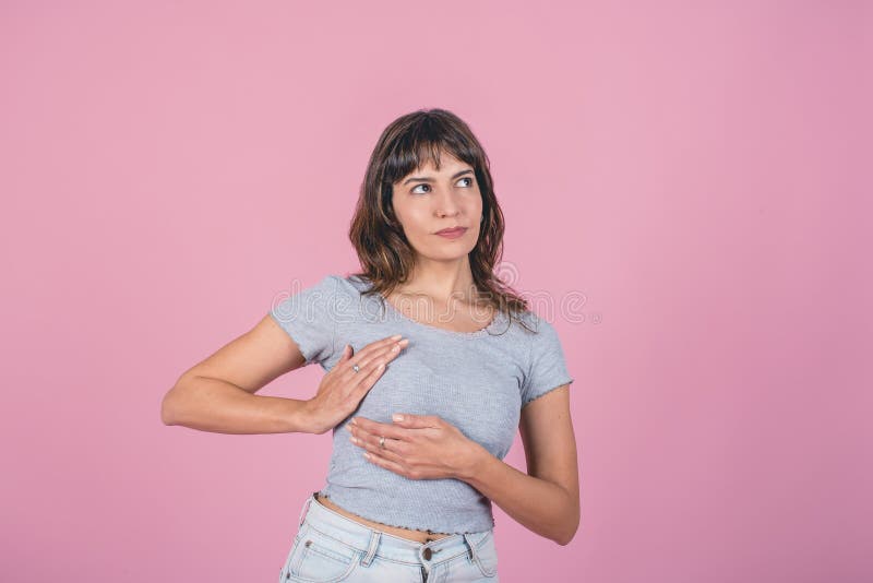 Woman Doing a Breast Self-Exam (BSE) while Looking at Camera Stock ...