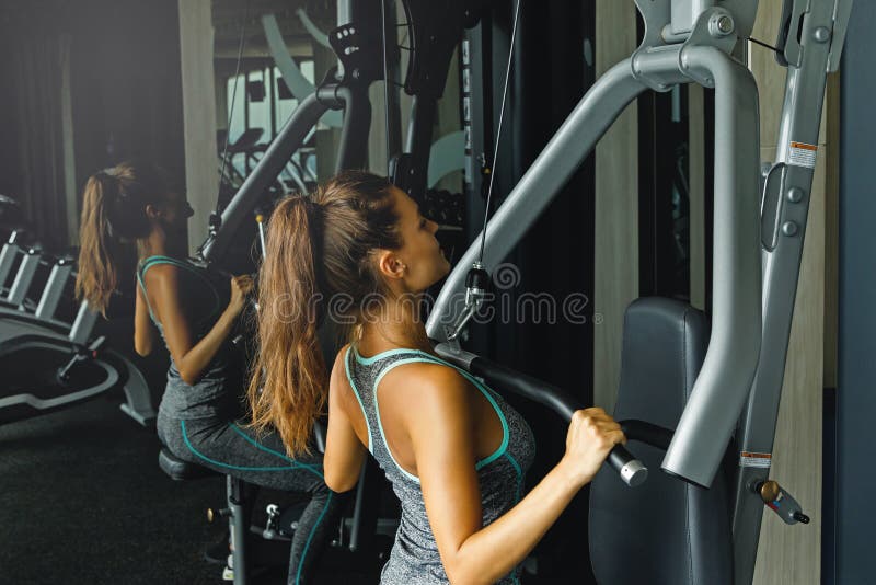 Woman Doing Exercise for Her Back in Gym Stock Photo - Image of ...