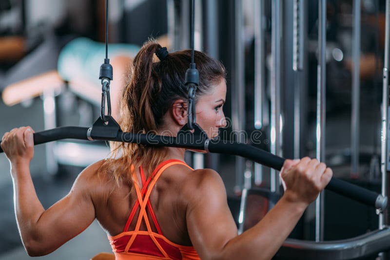 Woman Doing Exercise on a Lat Machine in Gym Stock Image - Image of ...