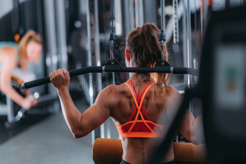 Woman Doing Exercise on a Lat Machine in Gym Stock Photo - Image of ...