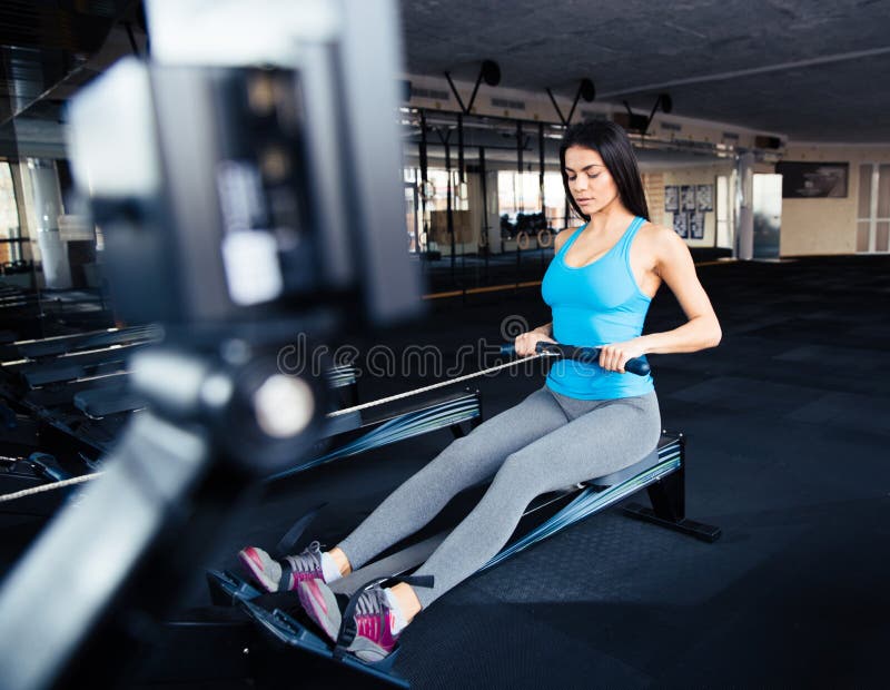 Woman Doing Exercise on Simulator at Gym Stock Photo - Image of ...