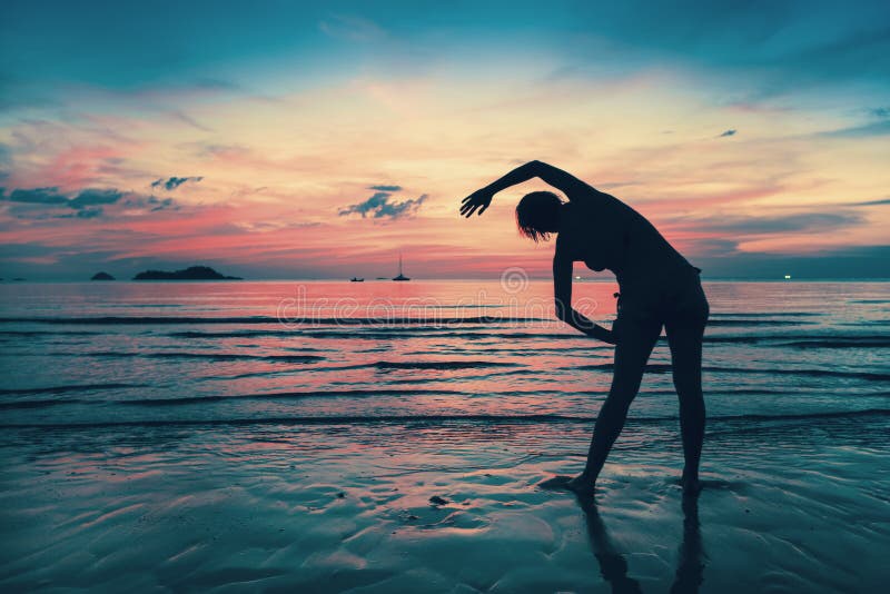 Woman Doing Exercises on the Beach during Sunset. Stock Photo - Image ...