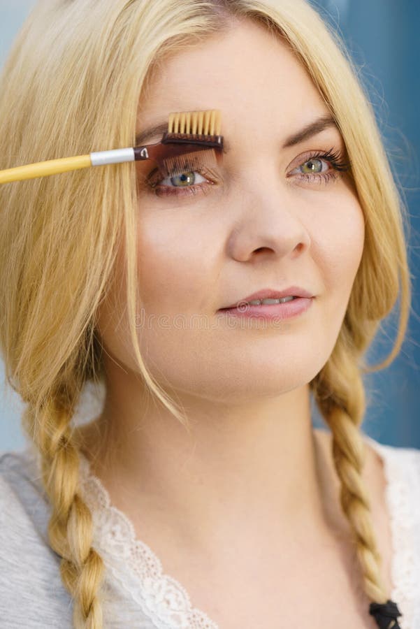 Woman Brushing Her Eyebrows Stock Image - Image of beautiful, comb ...