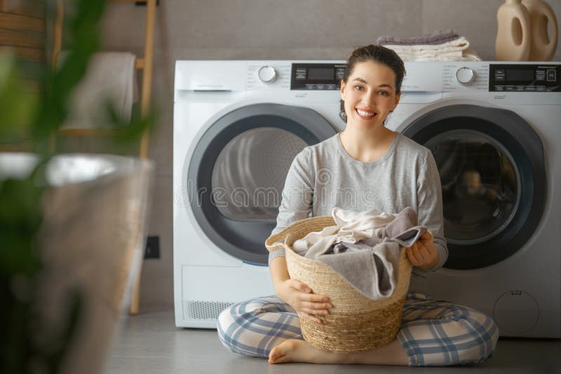 Woman is doing laundry stock image. Image of chore, laundry - 242858063