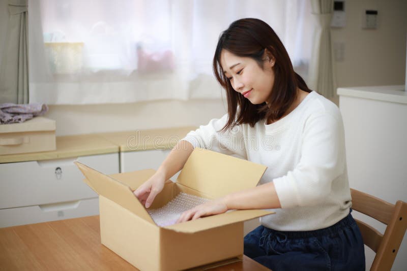 Woman doing packing work stock image. Image of auction - 244452843