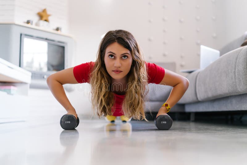 Woman Doing Push Ups with Dumbbells at Home Stock Photo - Image of ...