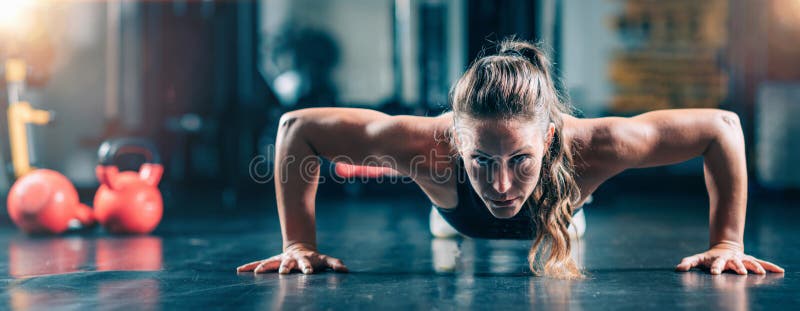 Woman Doing Push-ups in the Gym. Strength Training Stock Photo - Image ...