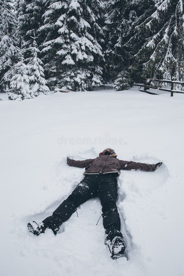 Woman Doing a Snow Angel in Heavy Snow. Winter Time Stock Image - Image ...