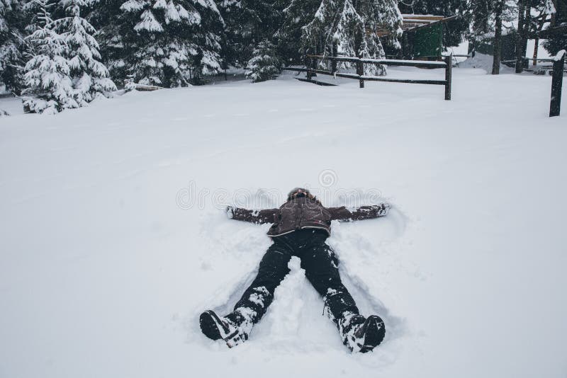 Woman Doing a Snow Angel in Heavy Snow. Winter Time Stock Photo - Image ...