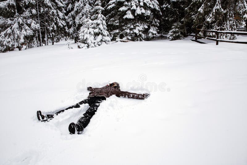 Woman Doing a Snow Angel in Heavy Snow. Winter Time Editorial ...