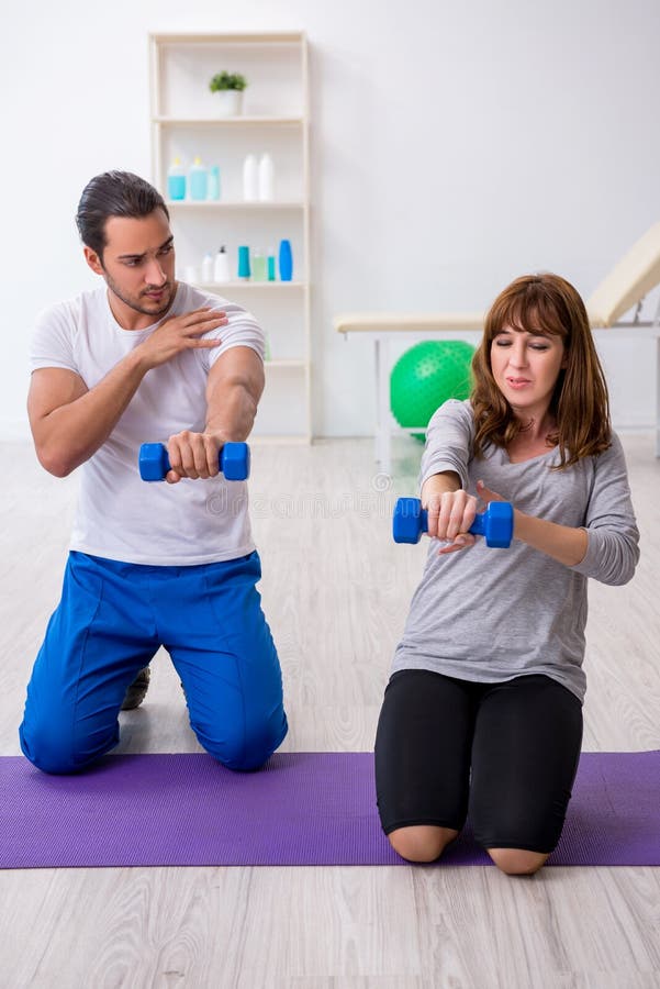 Young Woman Doing Sport Exercises with Personal Coach Stock Photo ...