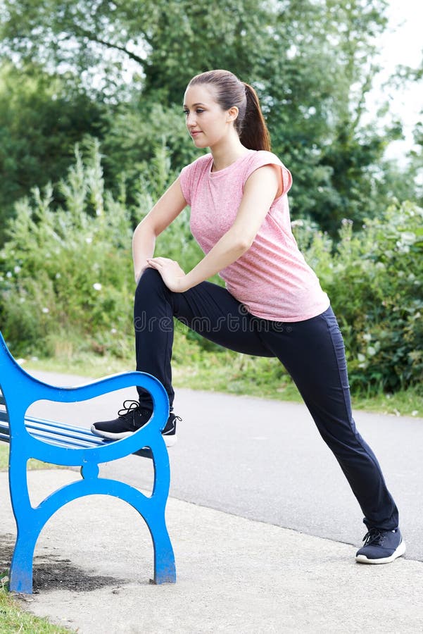 Woman Doing Stretches Using Park Bench Stock Image - Image of daytime ...