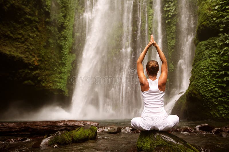 Woman Doing Yoga Near Waterfall Stock Photo - Image: 49342059