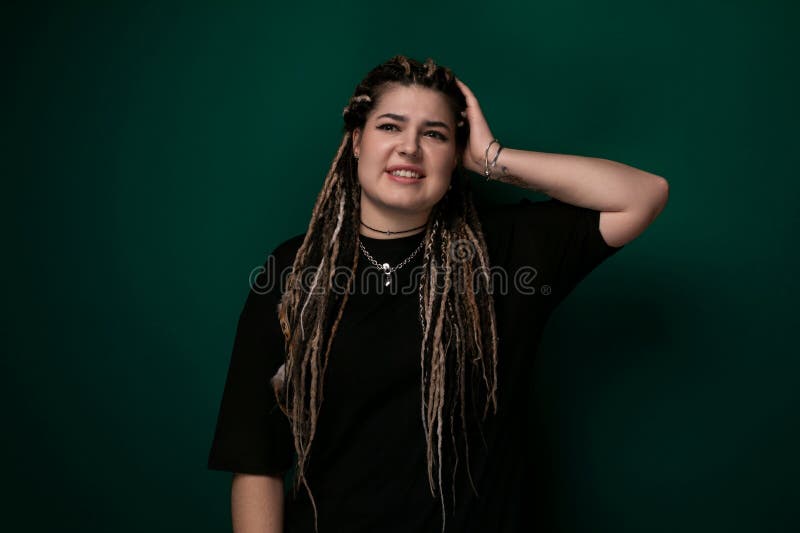 Woman with Dreadlocks Standing in Front of Green Background Stock Photo ...
