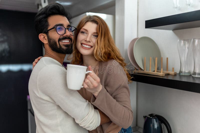 Woman Drinking Coffee with Man and Hugging while Sitting on Kitchen ...