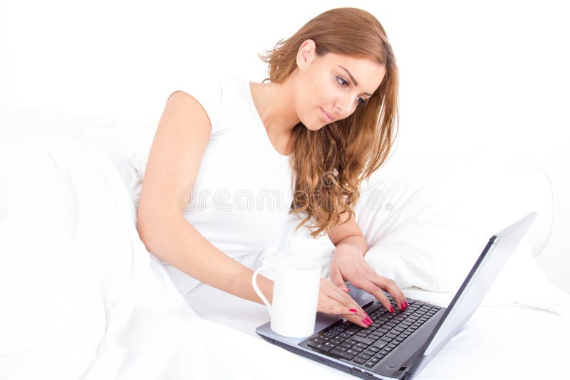 Woman Drinking Coffee / Tea Using Laptop Computer in Bed Stock Image ...