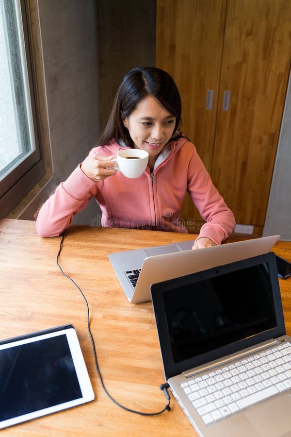 Woman Drinking a Cup of Tea and Using the Laptop Computer Stock Image ...
