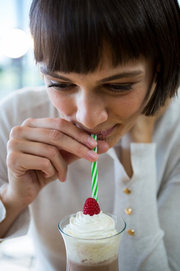 Woman drinking a milkshake stock photo. Image of drink - 26690376