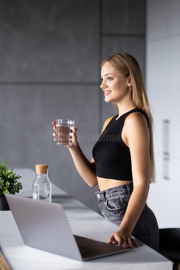 Young Woman Drinking Tap Water from Glass in Kitchen Stock Photo ...